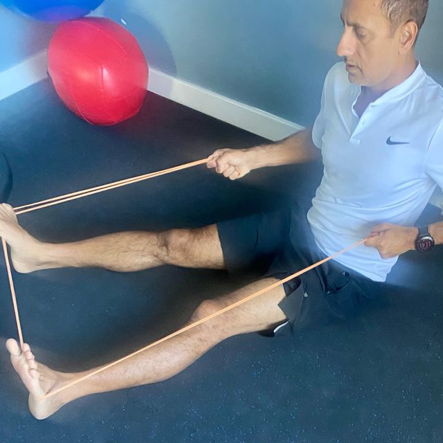seated row band around feet by Tony Madan - Exercise How-to - Skimble